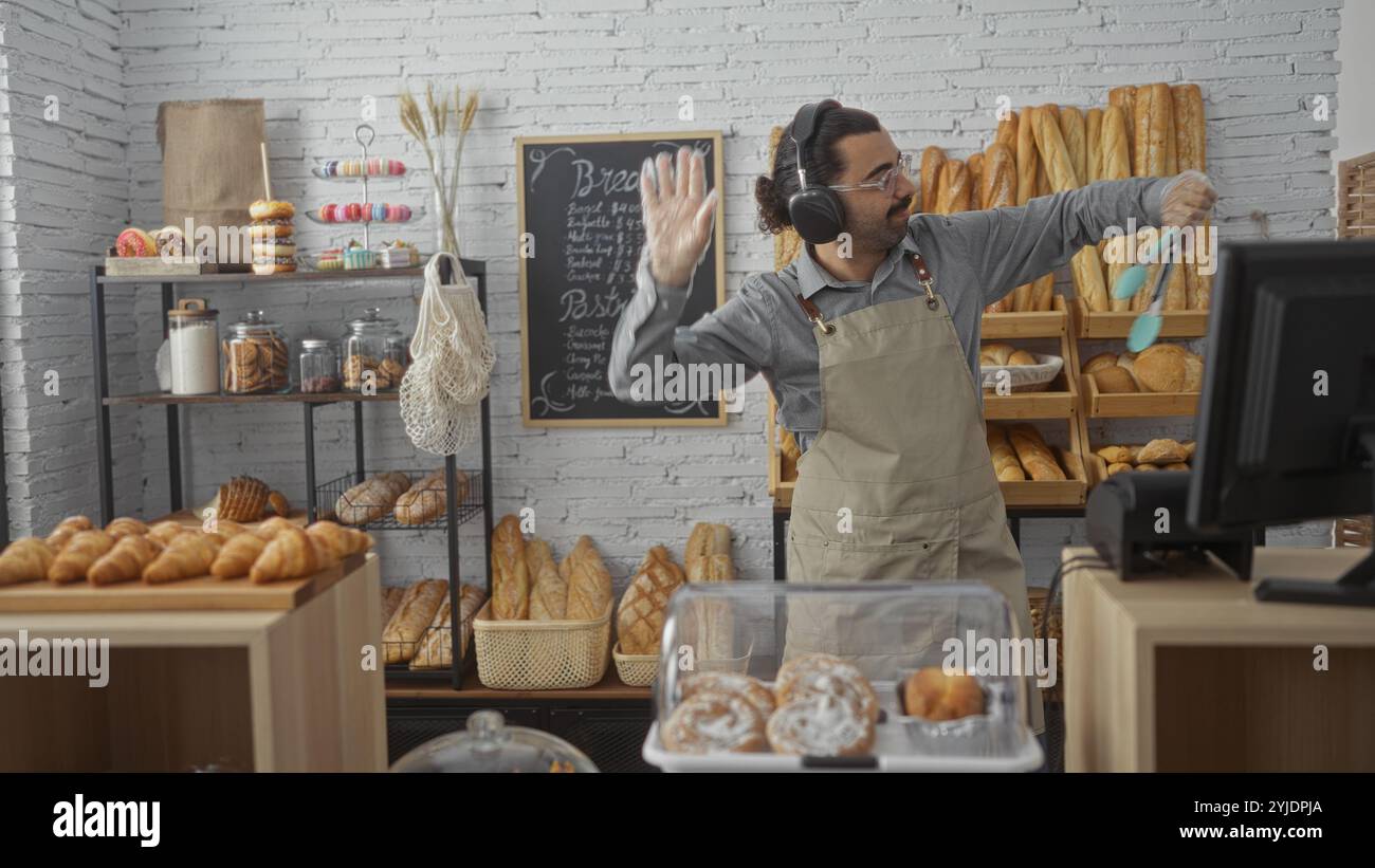 Young hispanic man with moustache dancing while working behind the ...