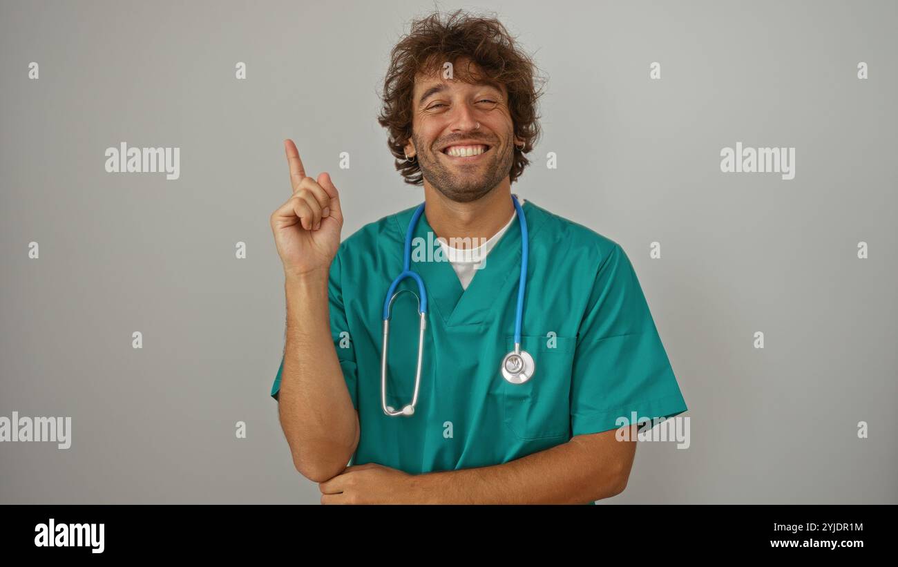 Medical professional pointing while smiling confidently in a green ...