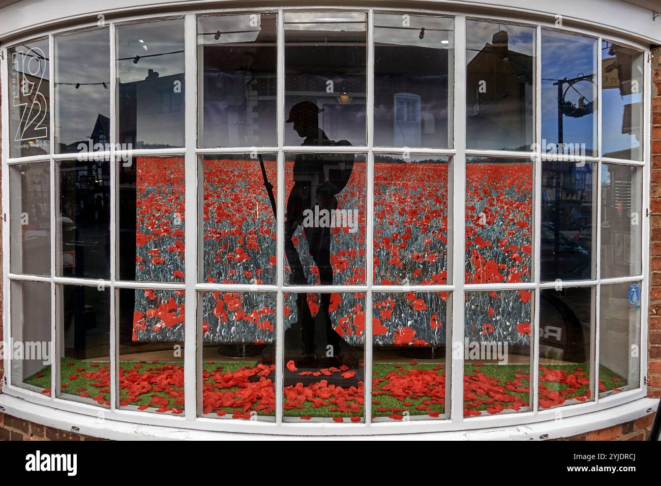 Remembrance day tribute with poppies and soldier in a UK shop window ...