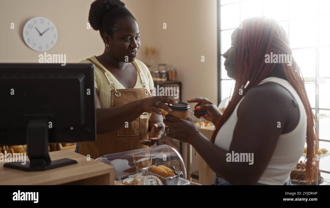 African american women interacting in a bakery shop, with one as an ...