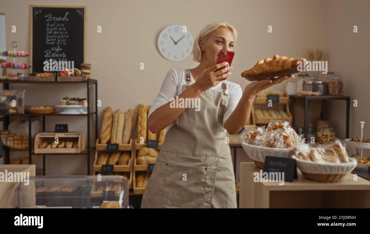 Woman taking photo of croissant in bakery shop with shelves of bread ...