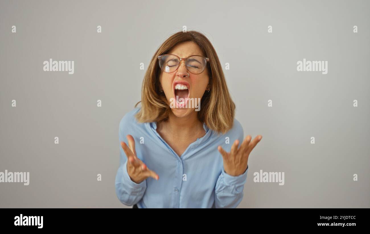 Woman yelling with frustration, showing emotion against a white ...
