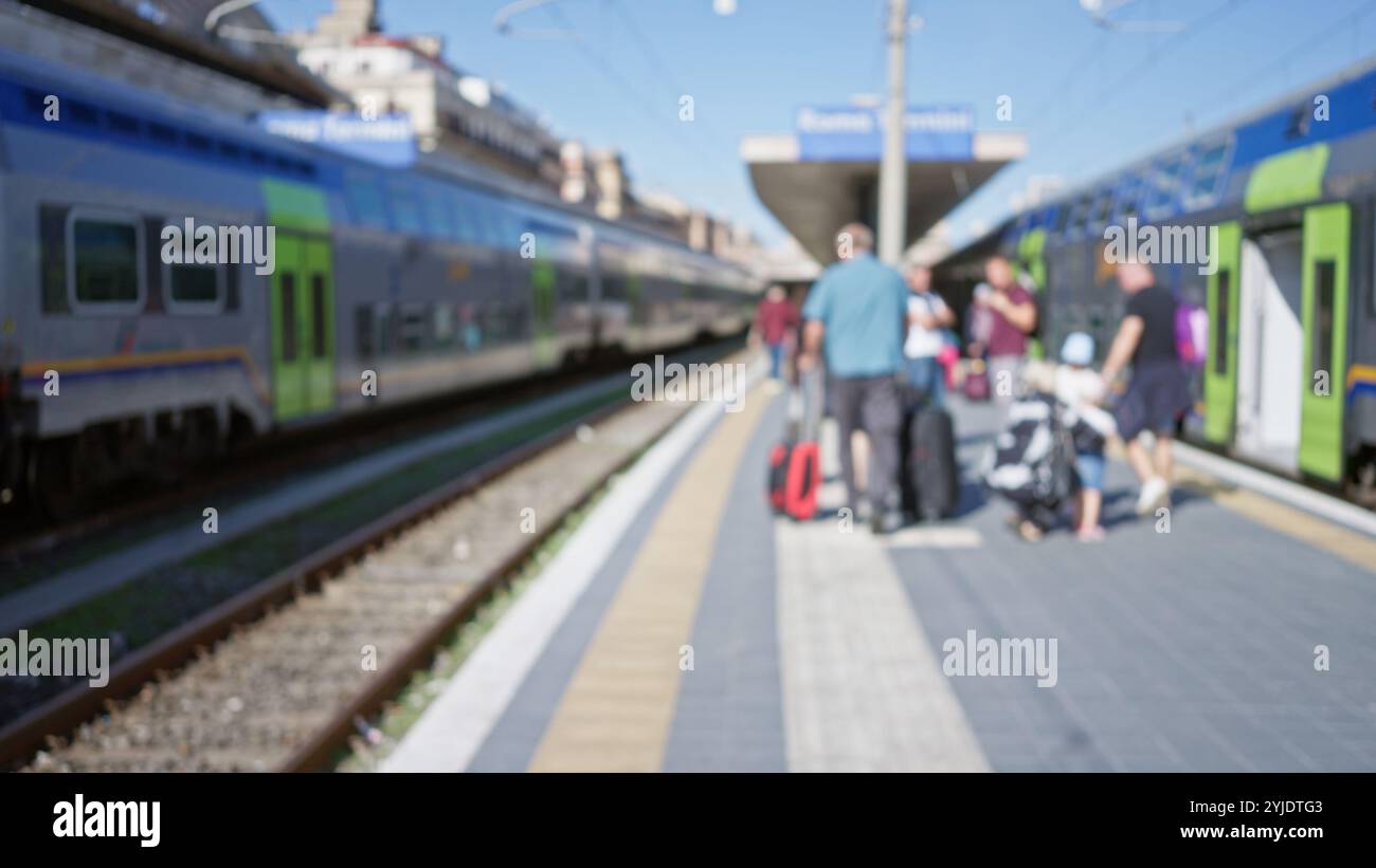 Blurred people at busy railway station platform with bright trains ...