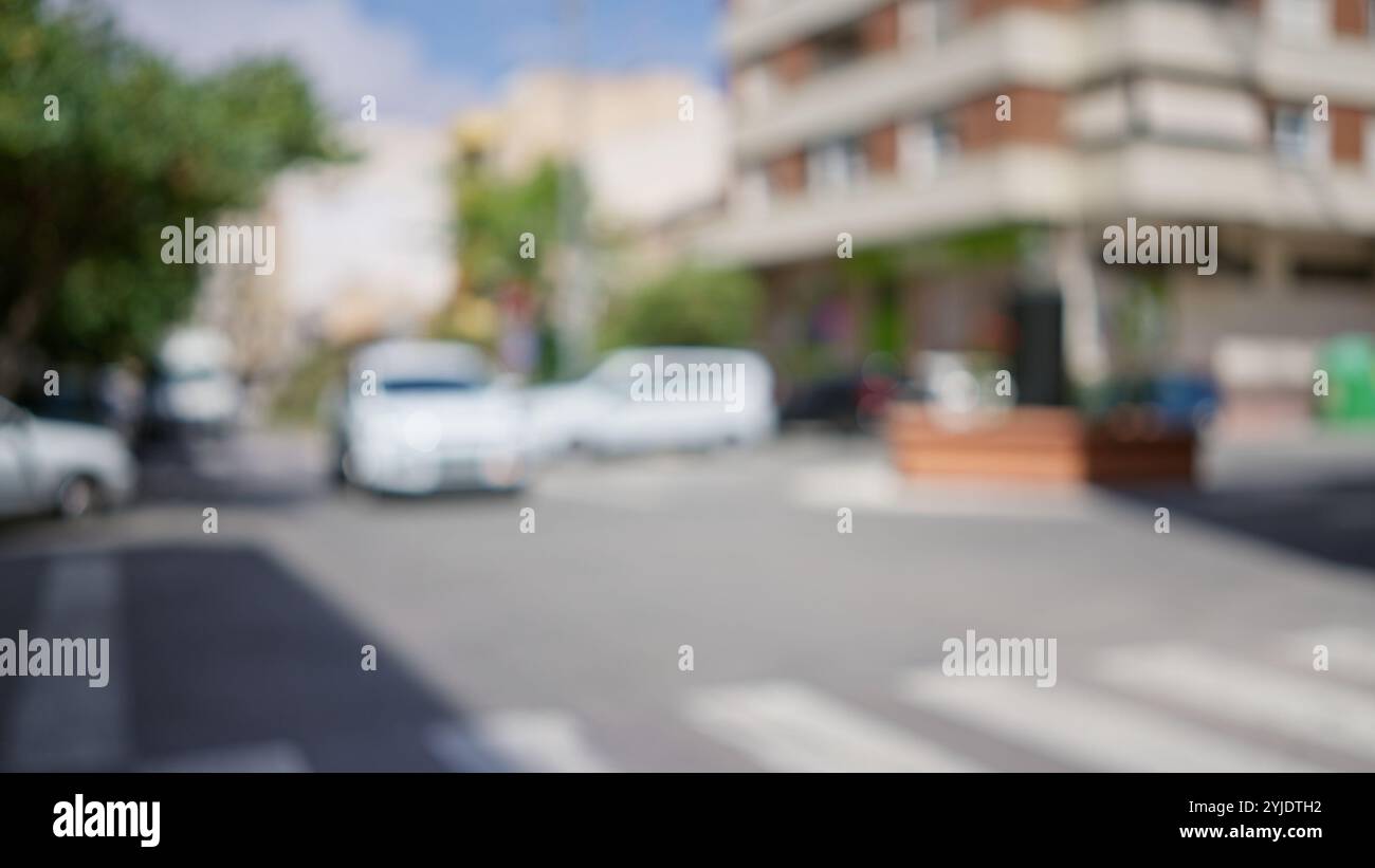 Blurred image of a city street with vehicles and buildings in the ...