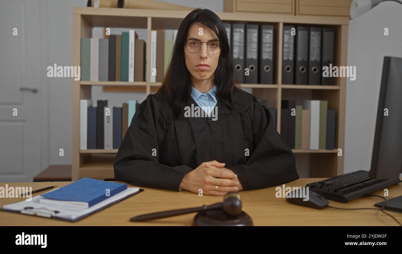 Female judge in office interior with gavel computer and legal documents ...