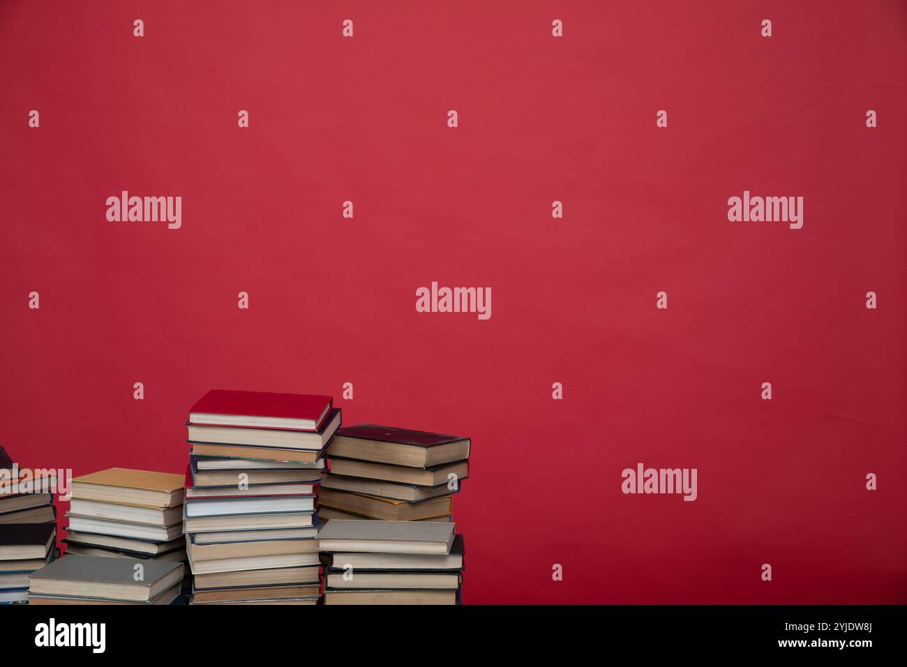 many stacks of educational books to study in the university library on ...
