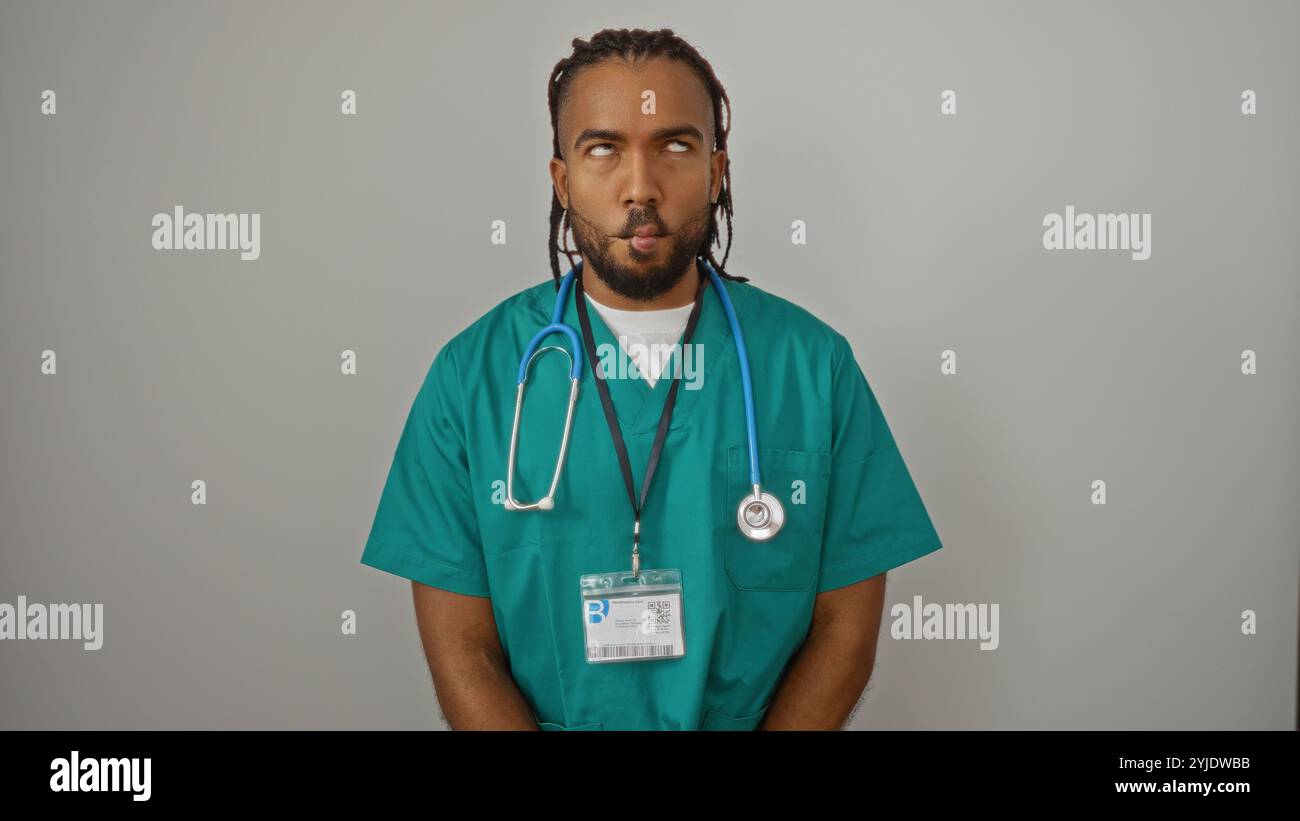 Man in green scrubs with braids makes a funny face isolated on white ...
