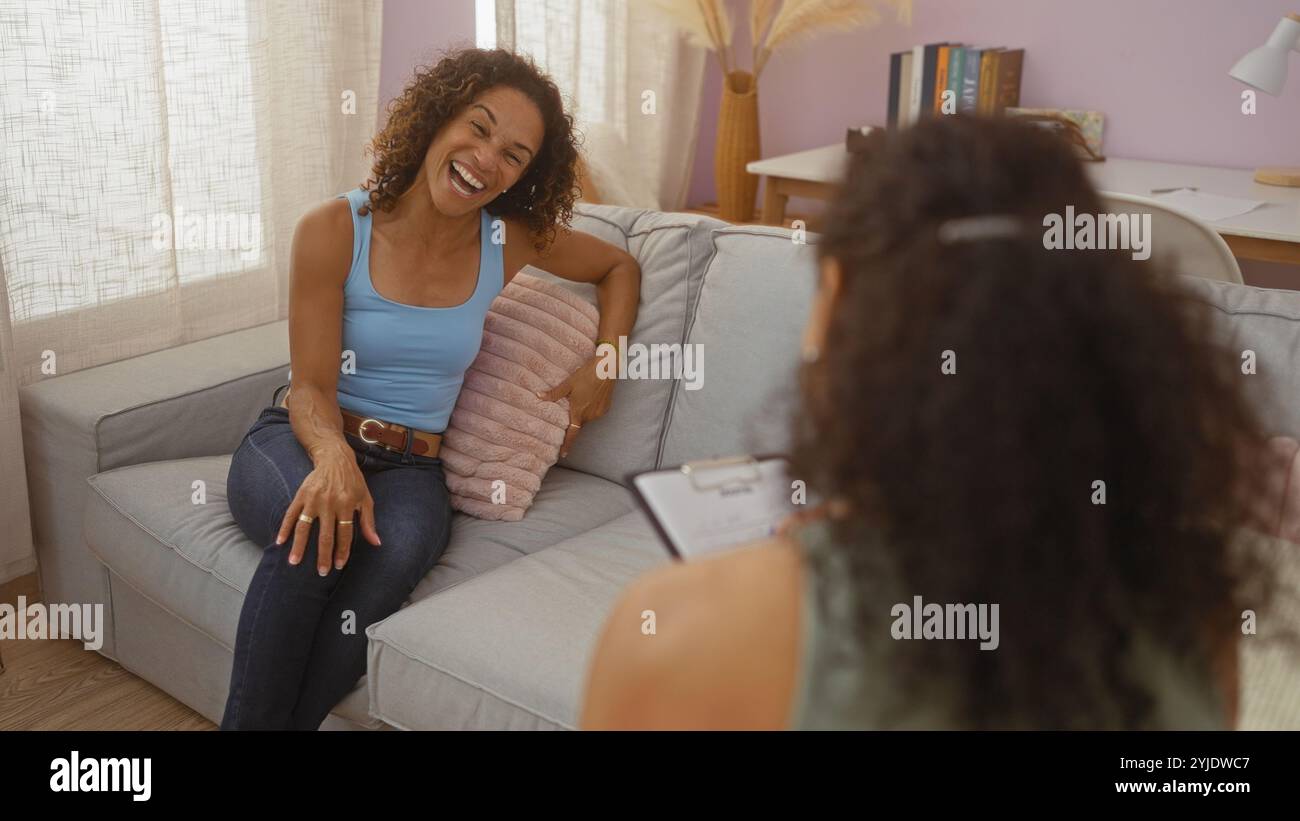 Woman smiling during therapy session with friend in cozy living room ...