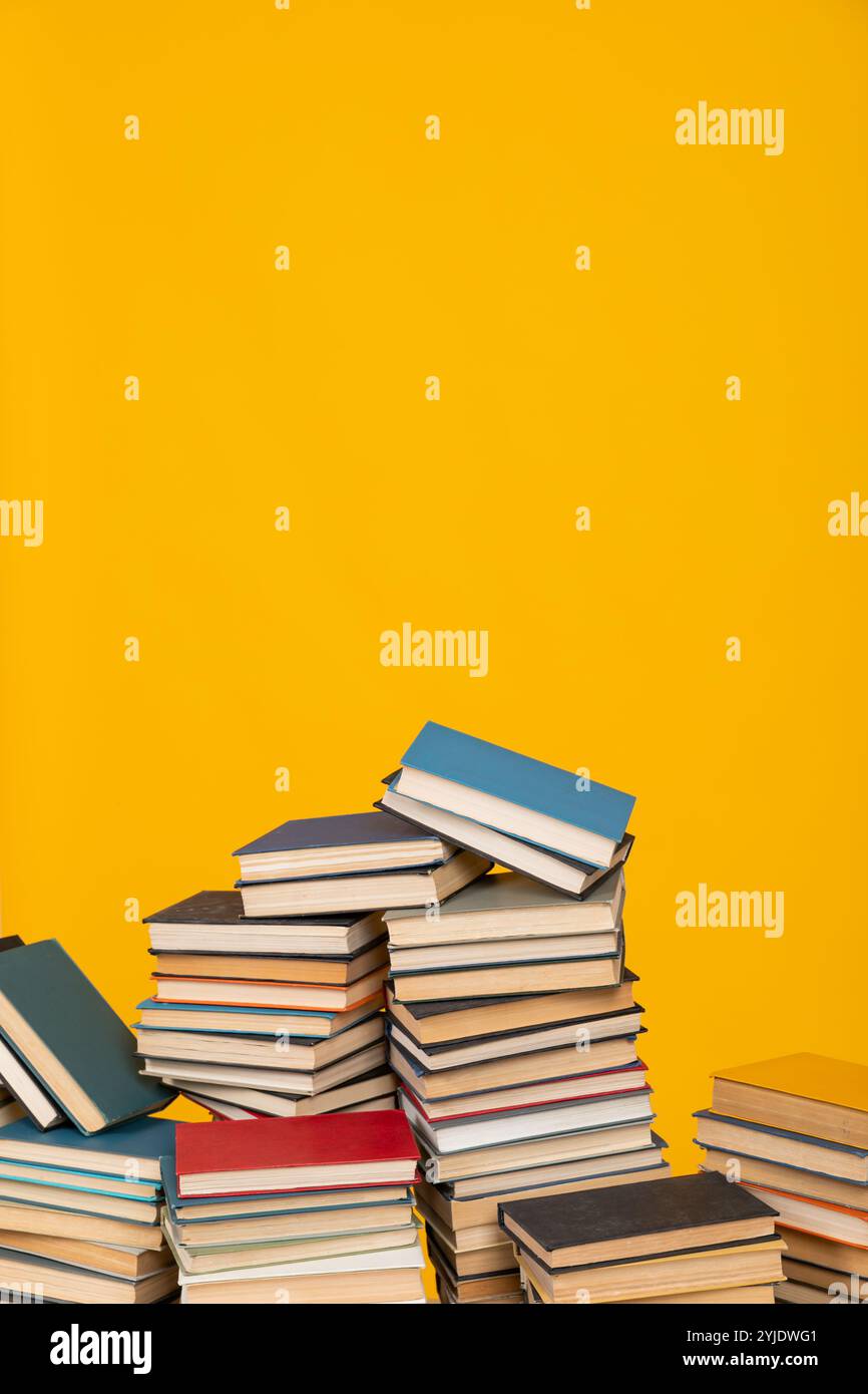 many stacks of books to study in the university library as a background ...