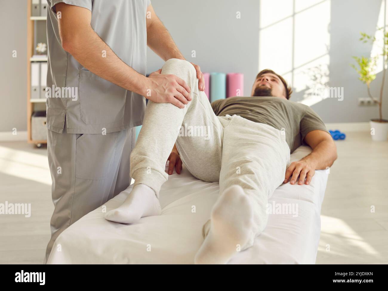 Therapist Conducting Rehabilitation Session With Man Patient Stock ...