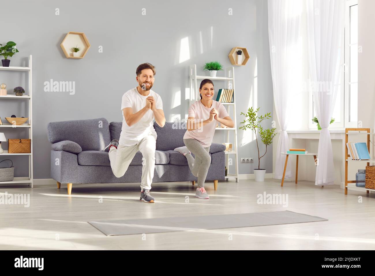 Active couple doing squats hi-res stock photography and images - Alamy