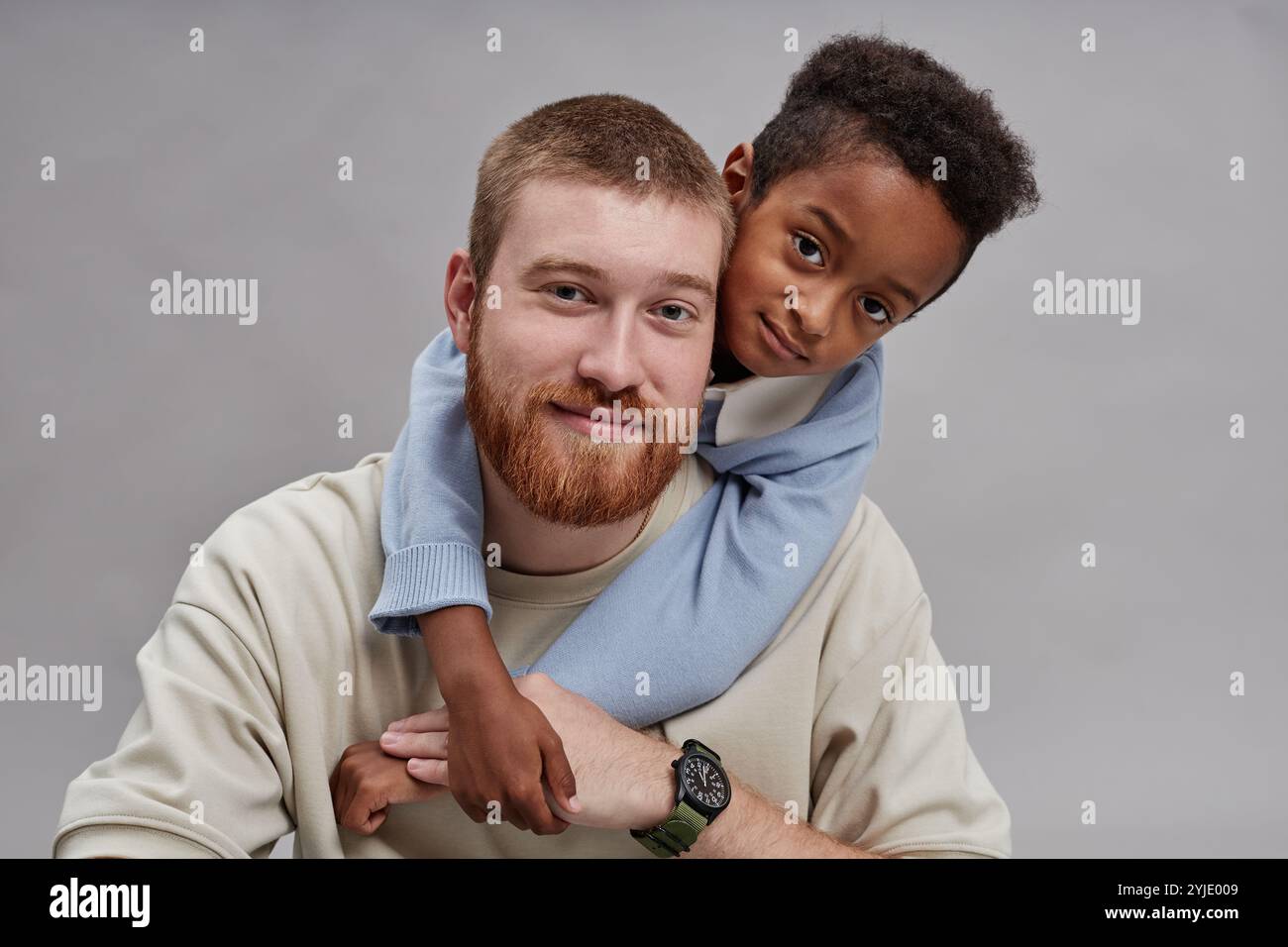 Portrait shot of adorable little Black boy holding hands with happy ...