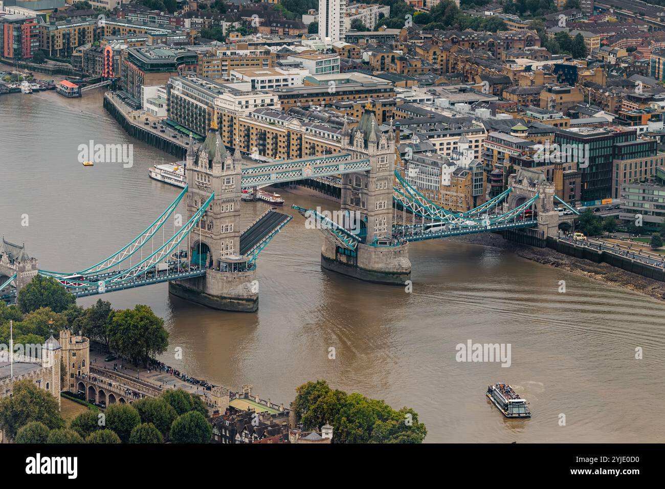An aerial view of Tower Bridge raised to allow tall ships to pass ...