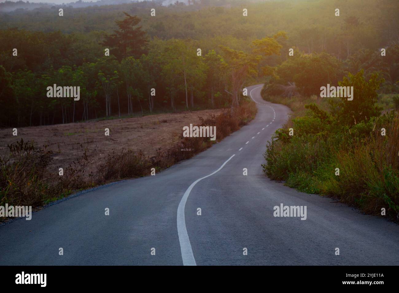 Beautiful curved road winding asphalt road from the top of the hill to ...