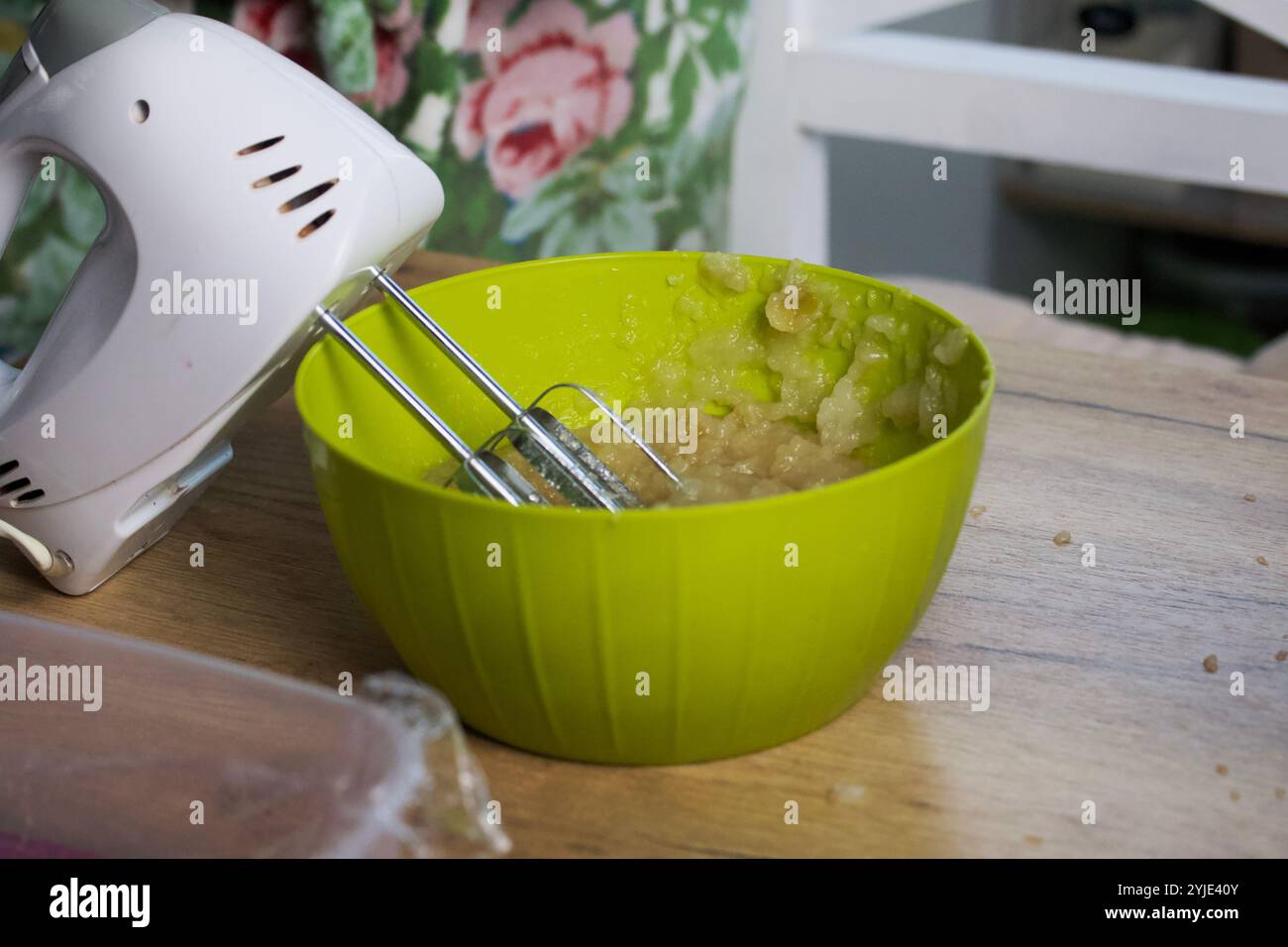 A blender in the woman hand. She is mixing the apple puree and gelatin ...