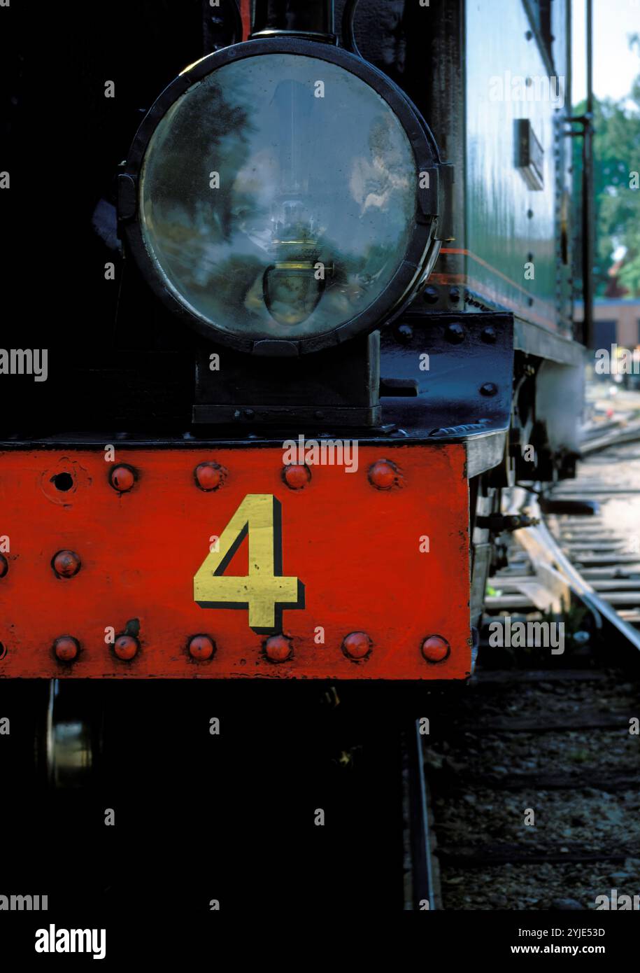 Closeup view of the front on an old steam locomotive. Headlight and ...