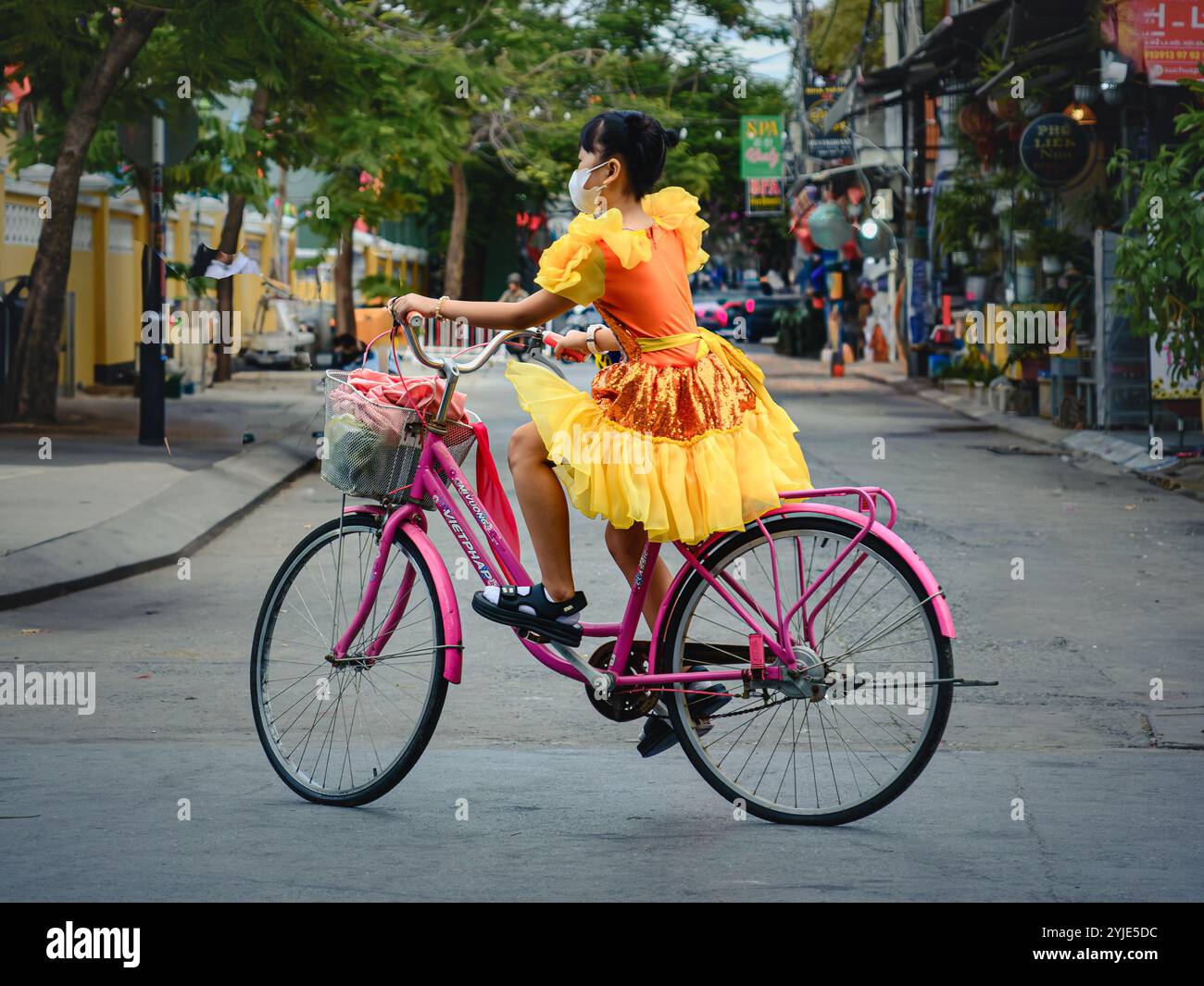 Woman riding bicycle in city dress hi-res stock photography and images ...
