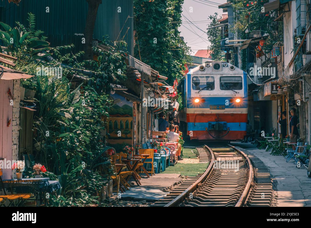 Vintage Tram Traveling Through Narrow Street with Colorful Buildings ...