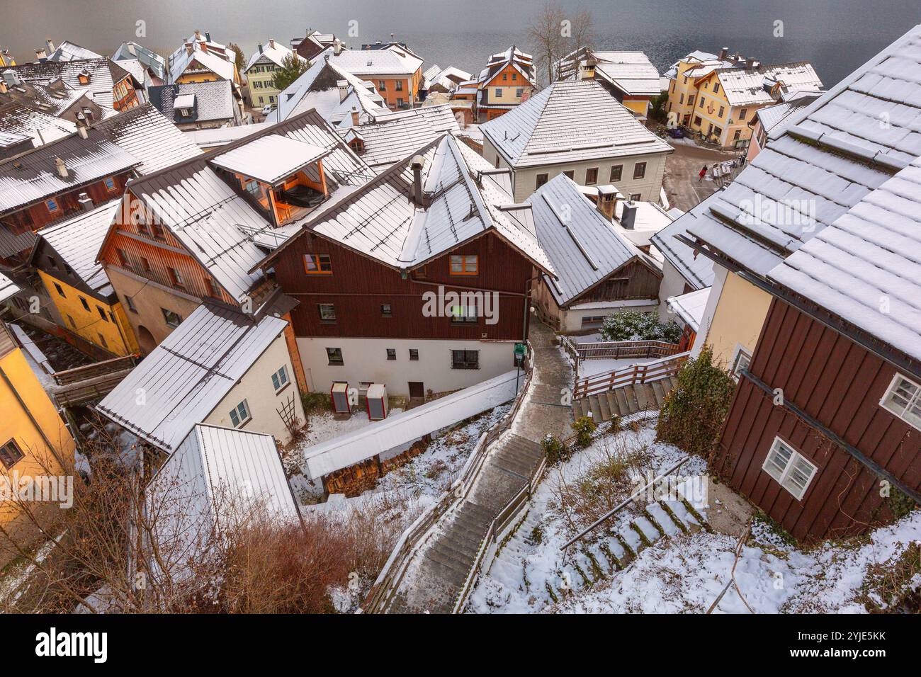 Aerial view of the village of Hallstatt in winter: snow-covered roofs ...