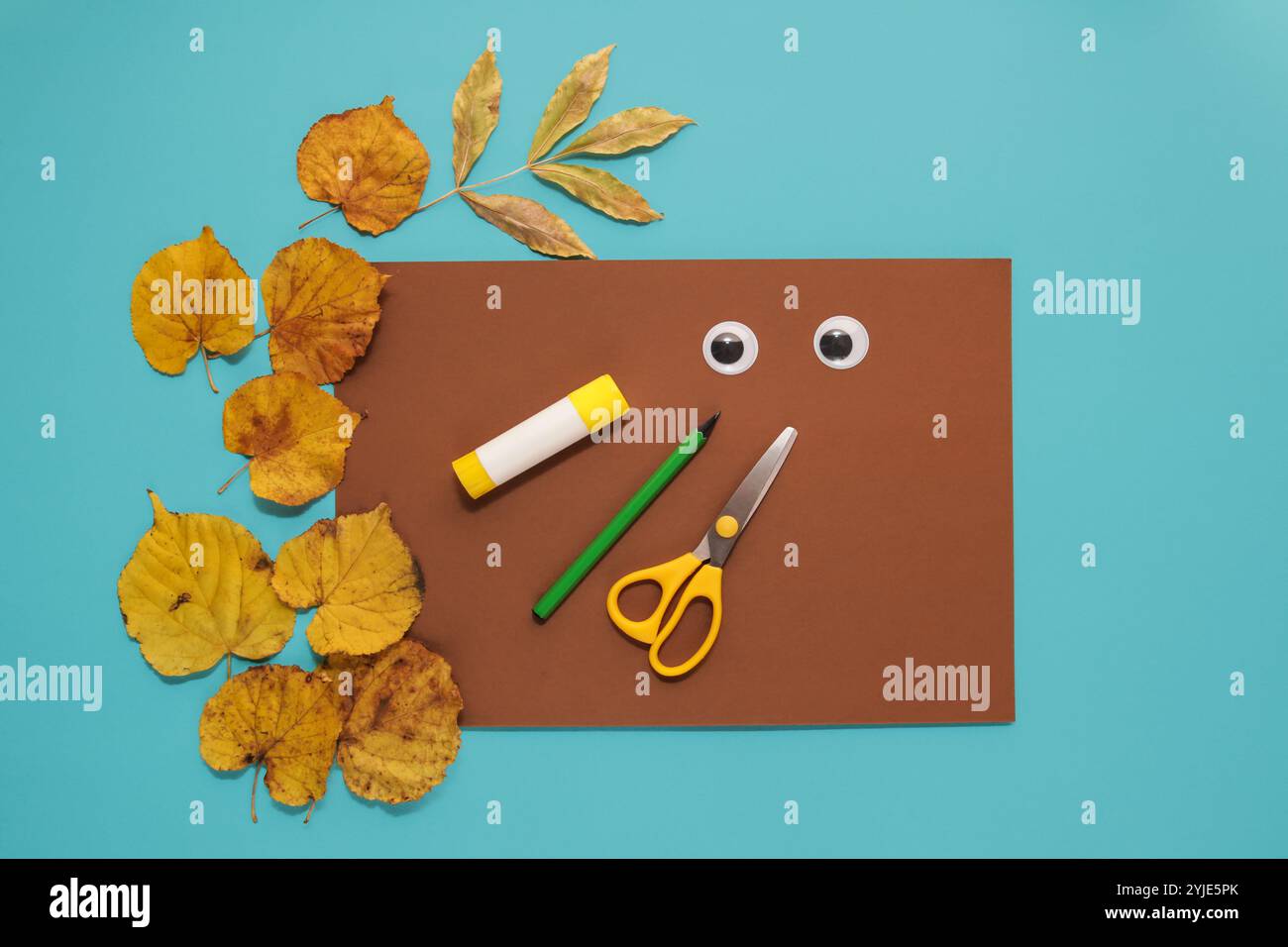 dry leaves applique art autumn. little child making autumn decoration ...