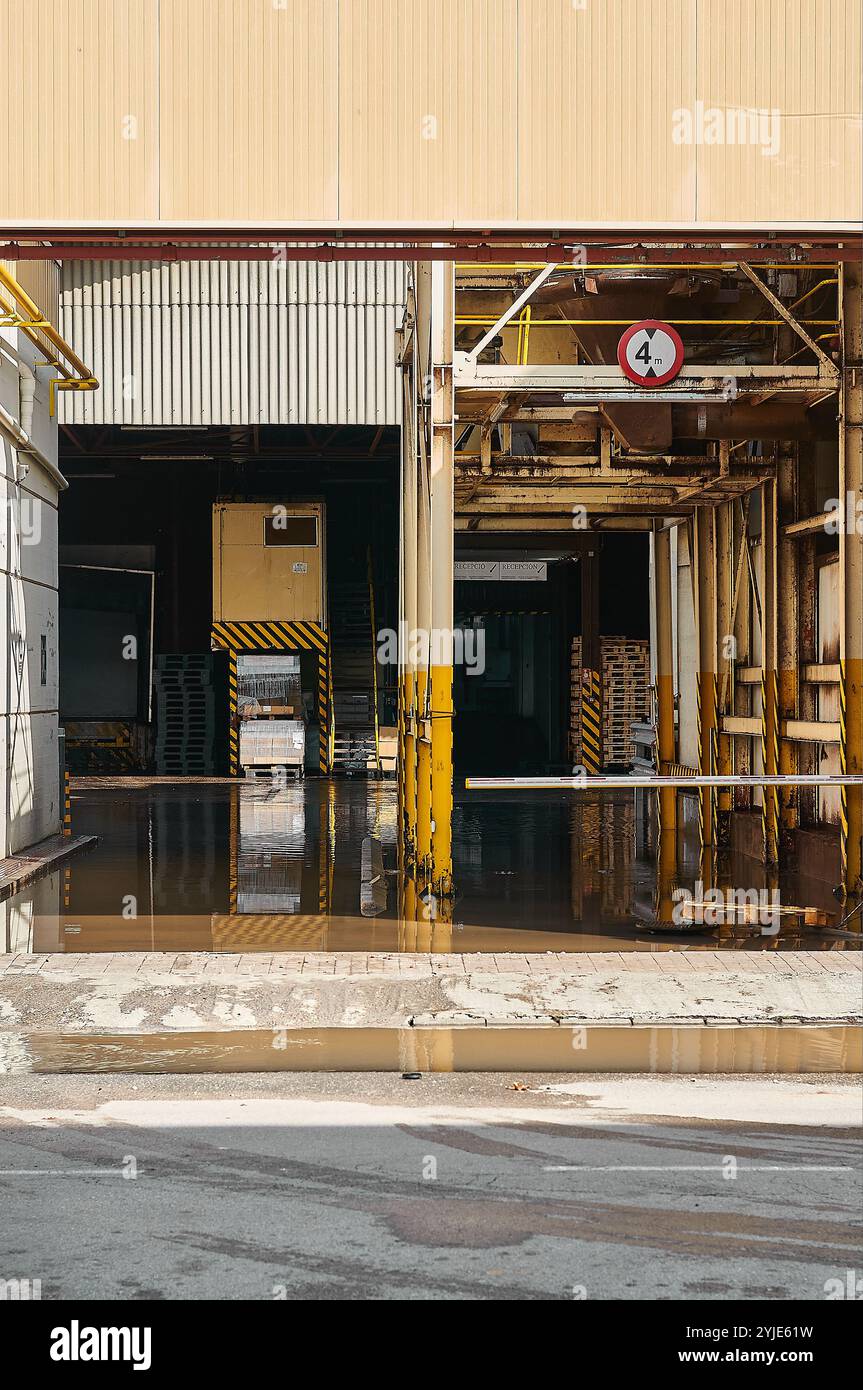 A detailed photo capturing an industrial facility submerged in water ...