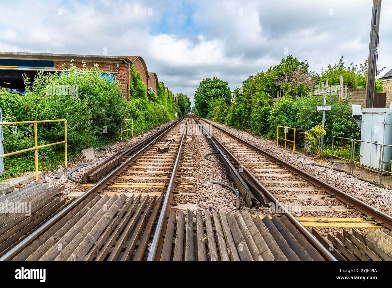 A view down the south coast railway line at a level crossing in ...