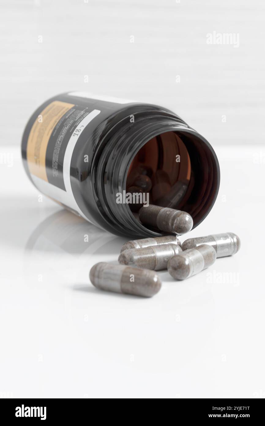 Pharmaceutical capsules out of their container Stock Photo - Alamy