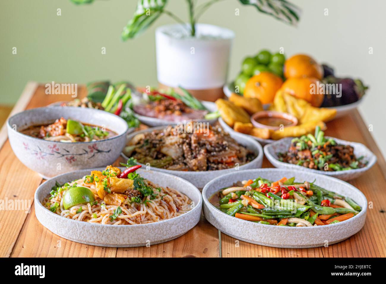 A variety of Tai Yai food is served on the table inside the restaurant ...