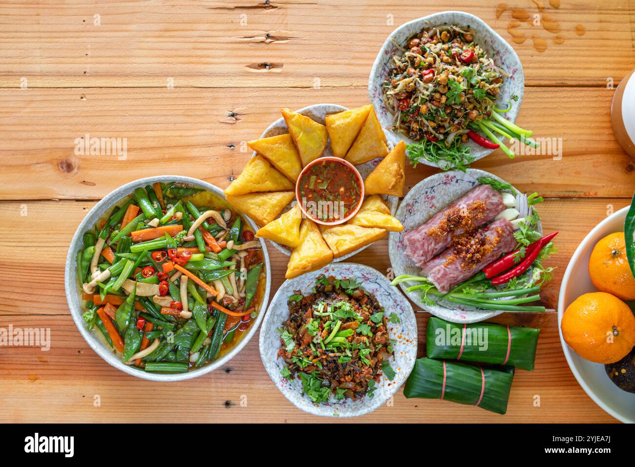 A variety of Tai Yai food is served on the table inside the restaurant ...