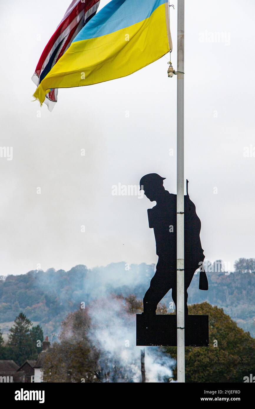 Silhouettes of an unkown soldier against a backdrop of the Ukraine flag ...
