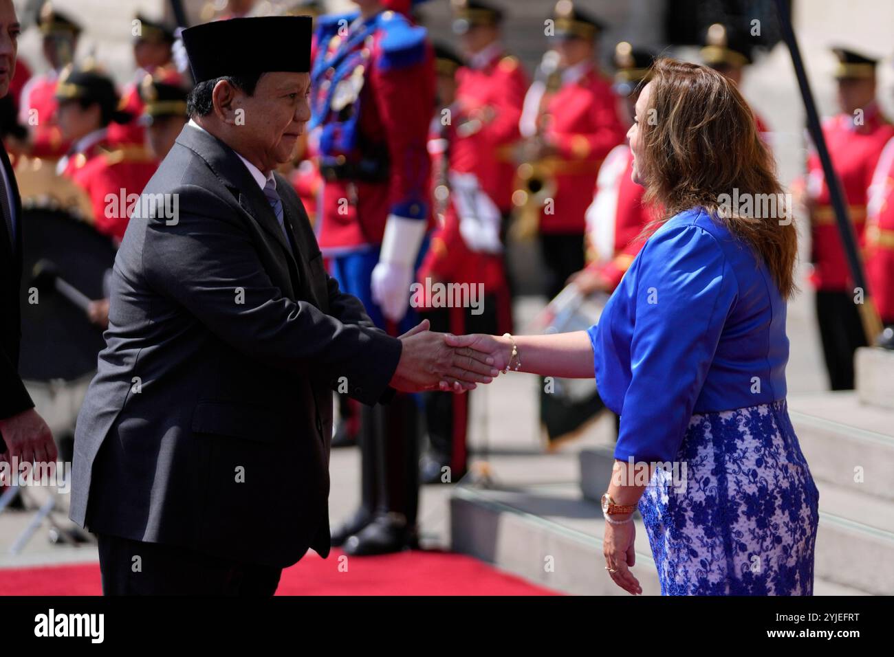 Indonesian President Prabowo Subianto, left, shakes hands with Peru's ...