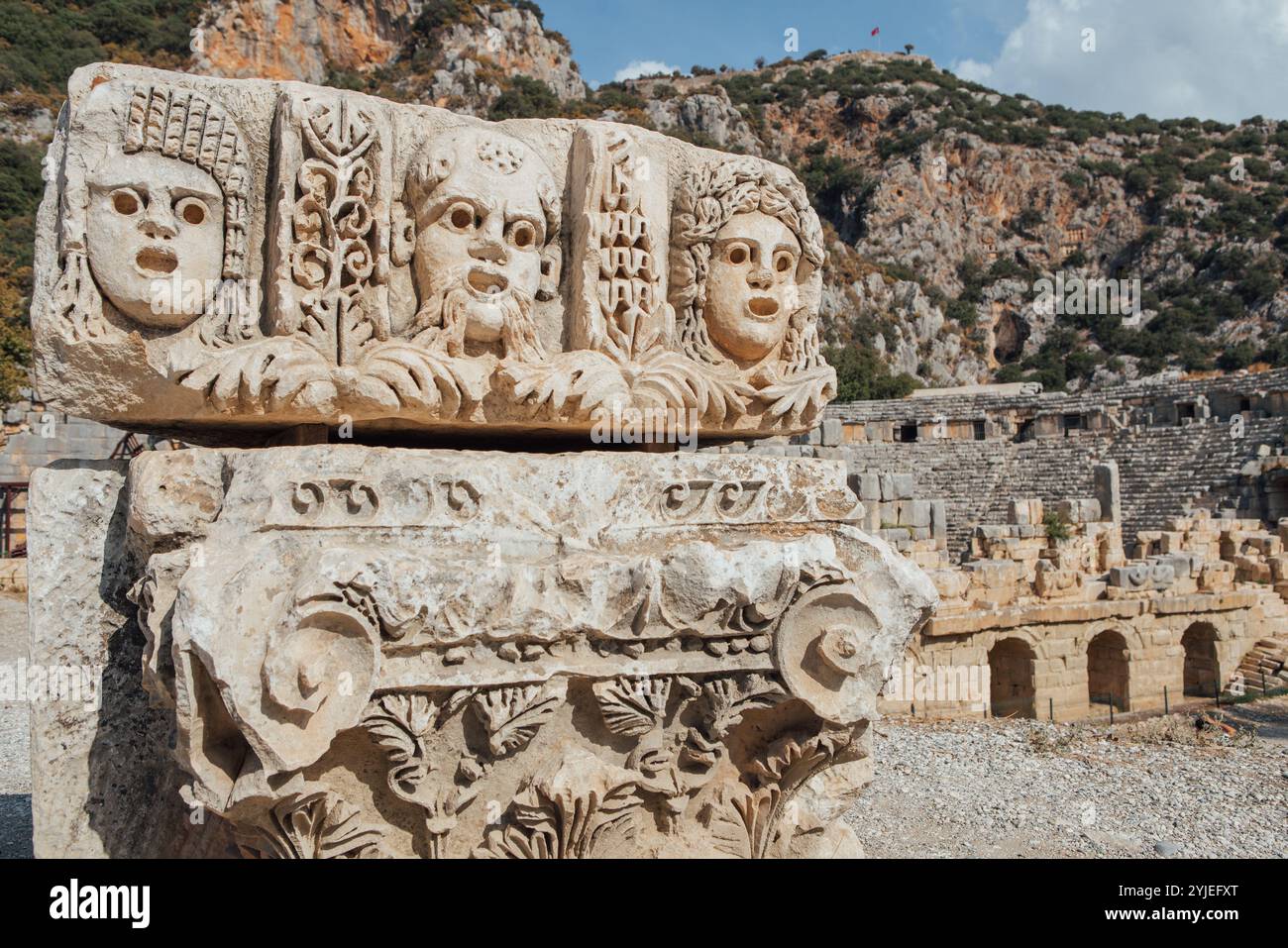 Historical stone bas-relief with carved faces in ancient city of Myra ...