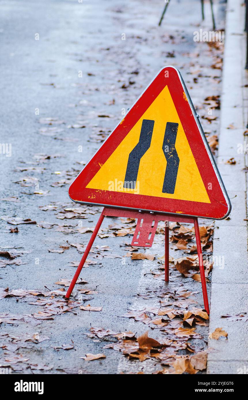 traffic sign warning of narrowing of the roadway, traffic signal ...