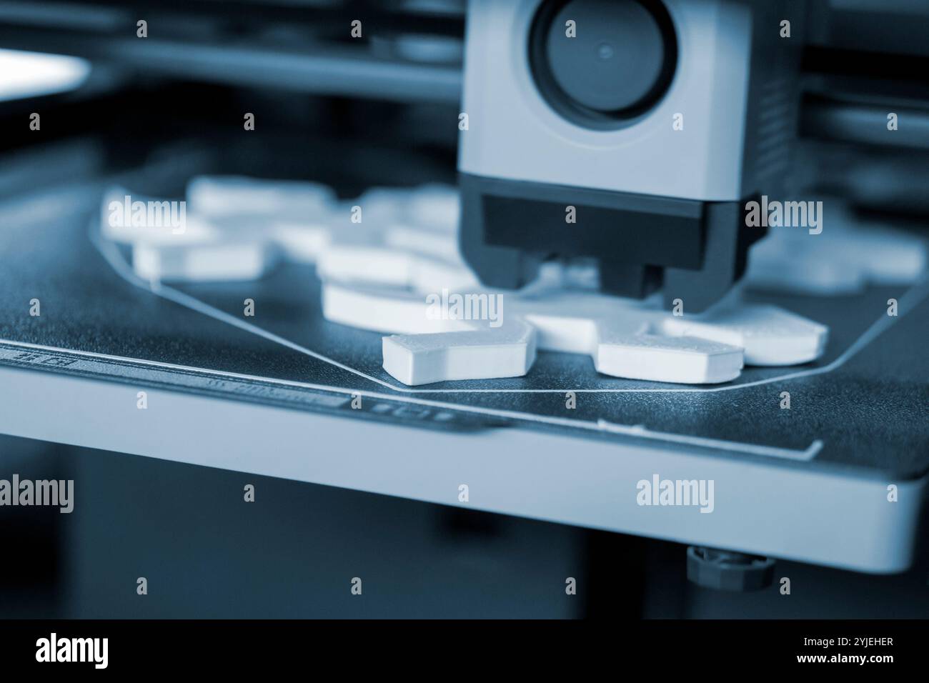 Process of printing on 3D printer. 3D printer creating model from molten plastic close-up ...