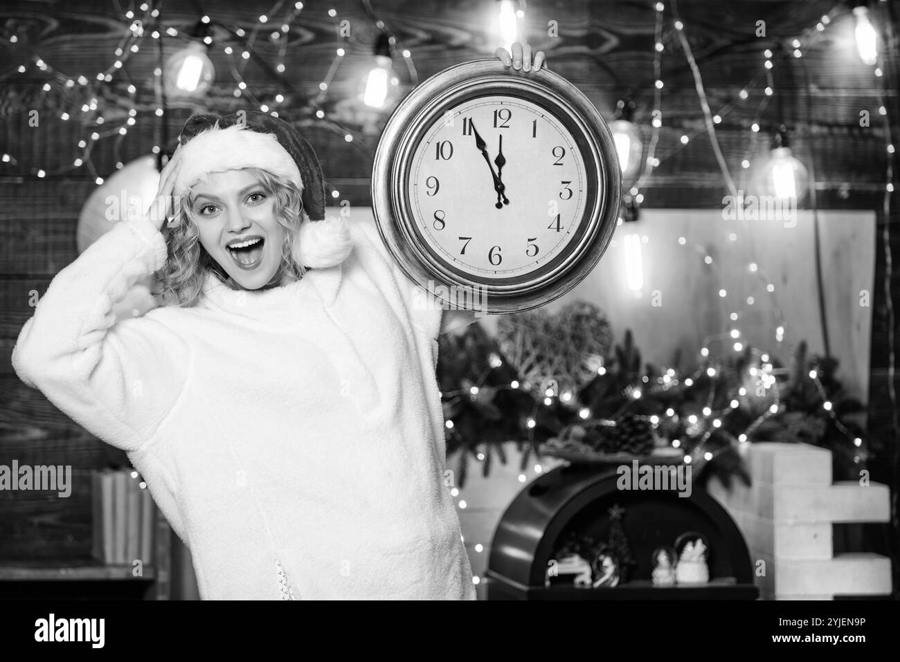 Woman Santa hat hold vintage clock. Time for winter party. Unexpectedly ...