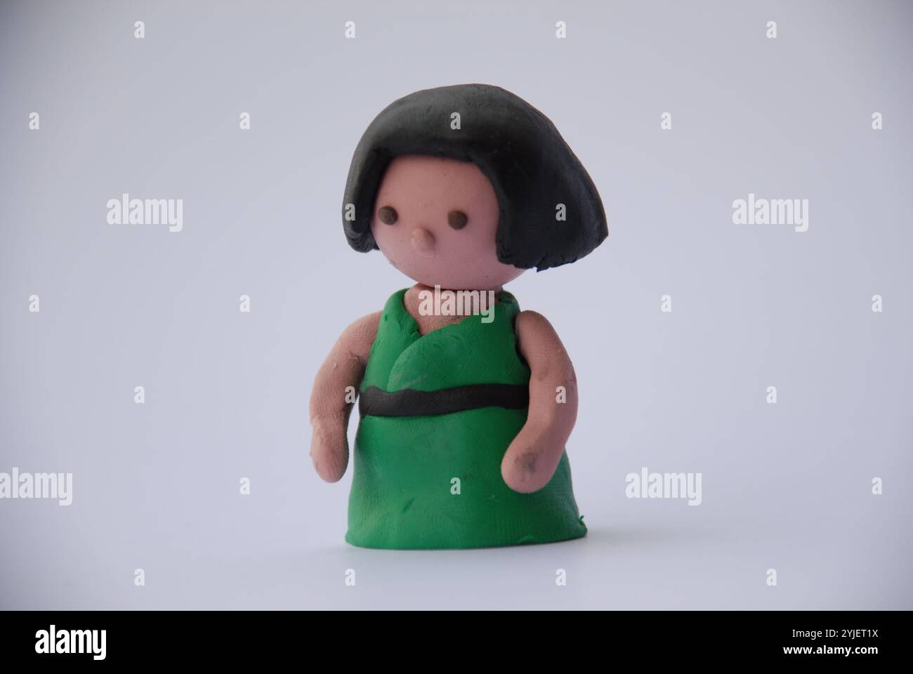 3D rendering in stylized clay of young woman with dark hair and wearing ...