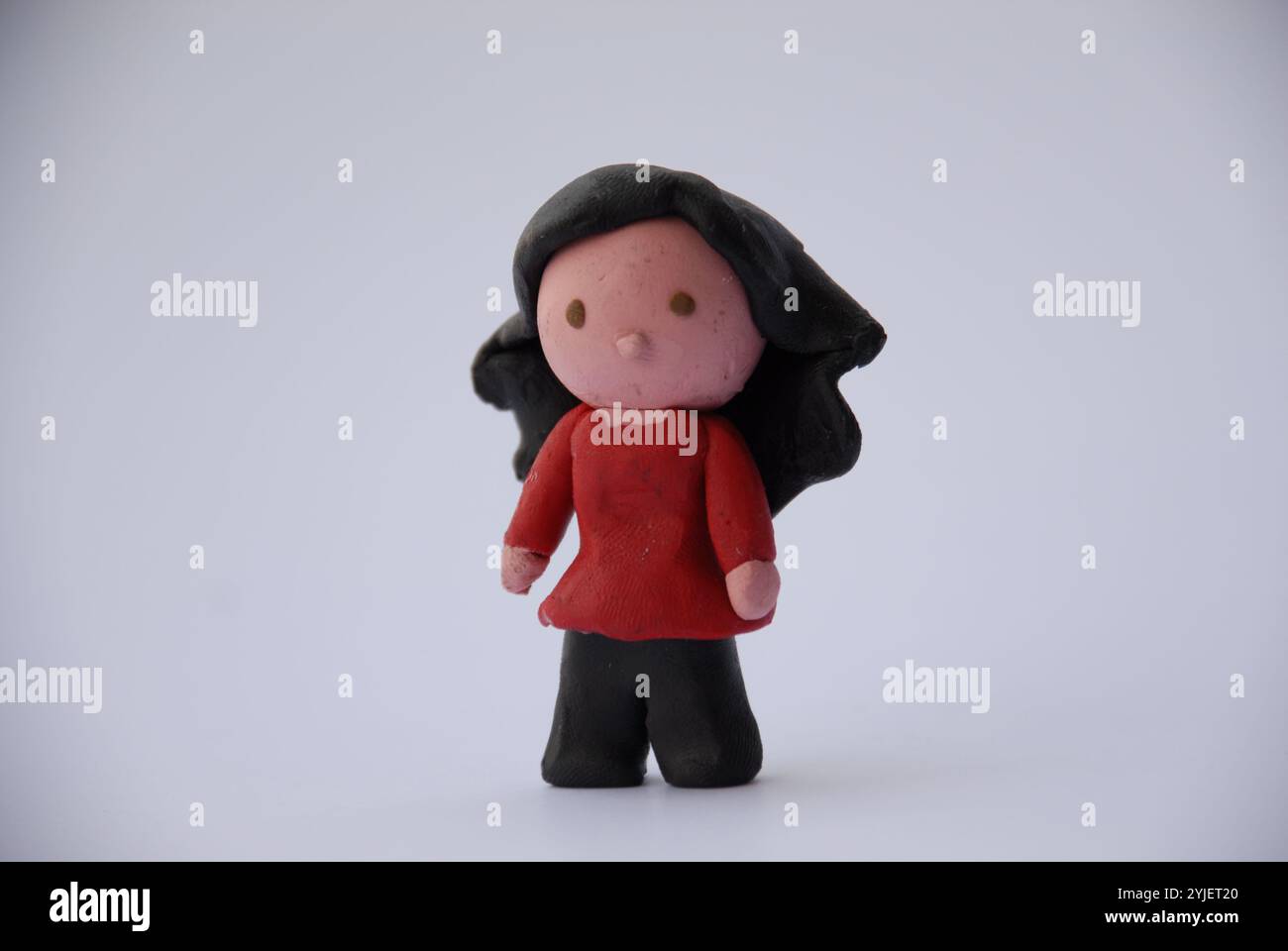 3D rendering in stylized clay of young woman with dark hair and wearing ...