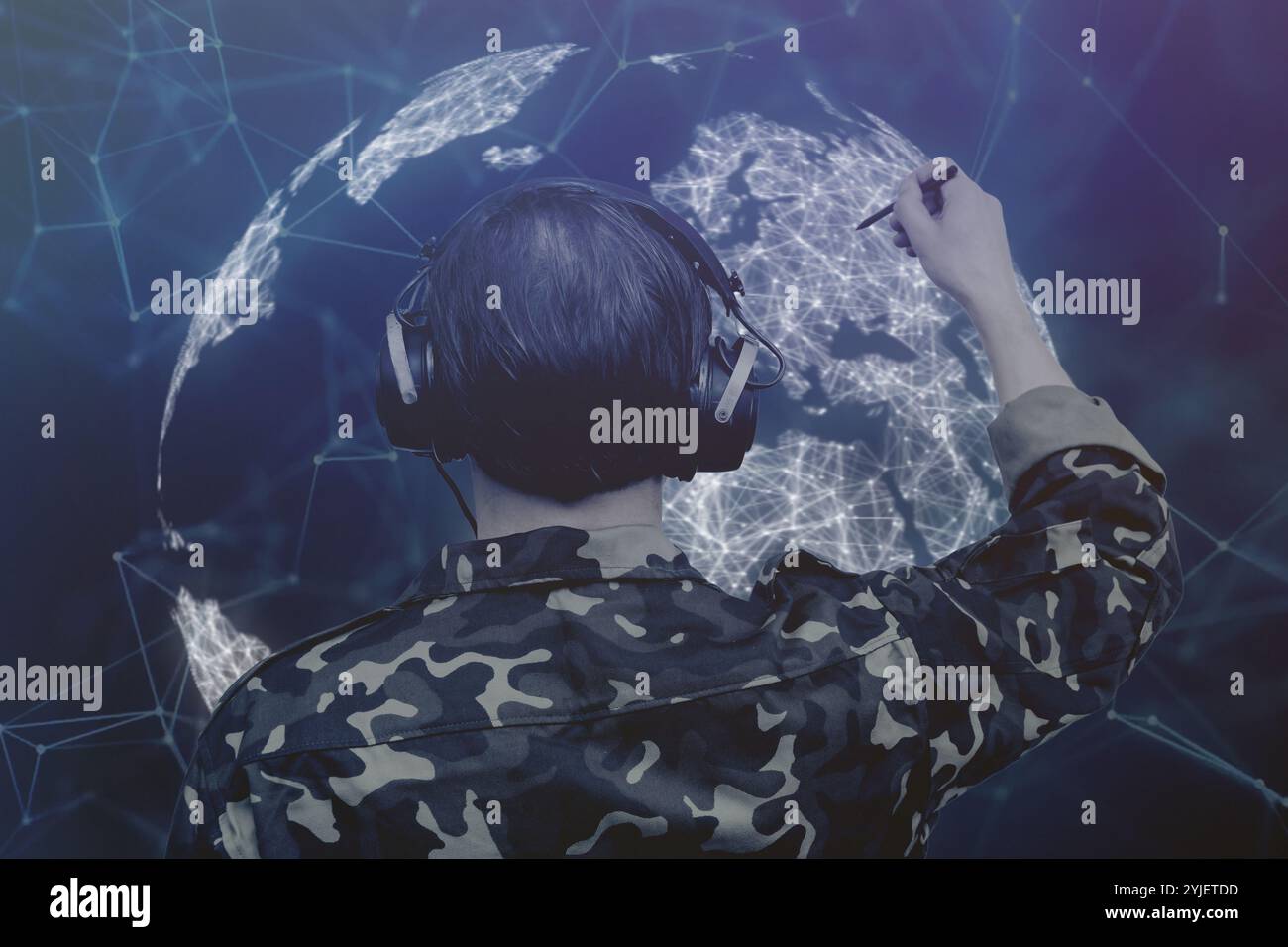 A military man with headphones marks a glowing point on the world map ...