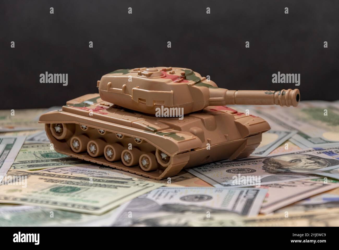 Two military tanks, American dollars, close-up. Concept: arms spending ...