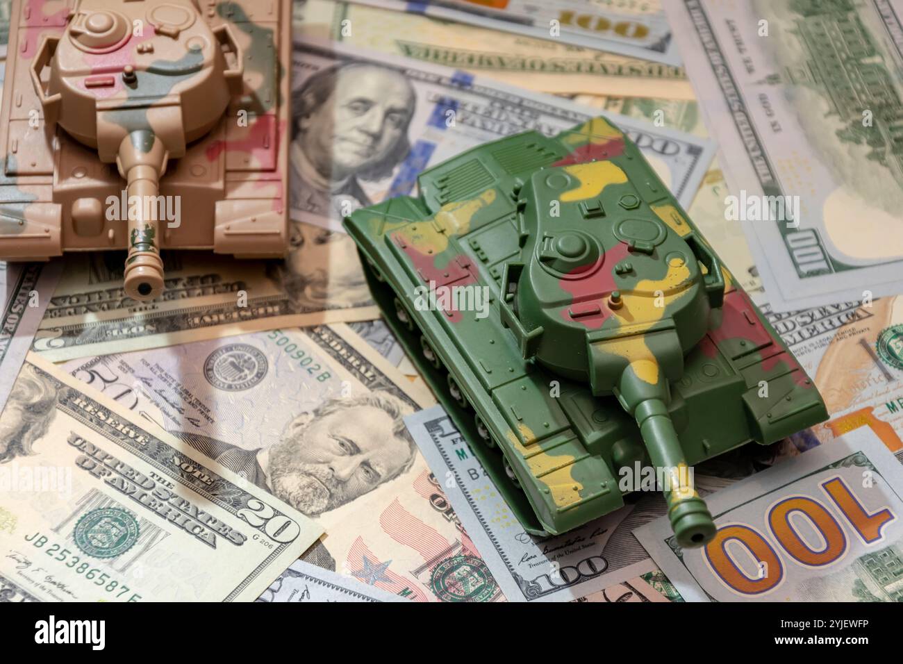 Two military tanks, American dollars, close-up. Concept: arms spending ...