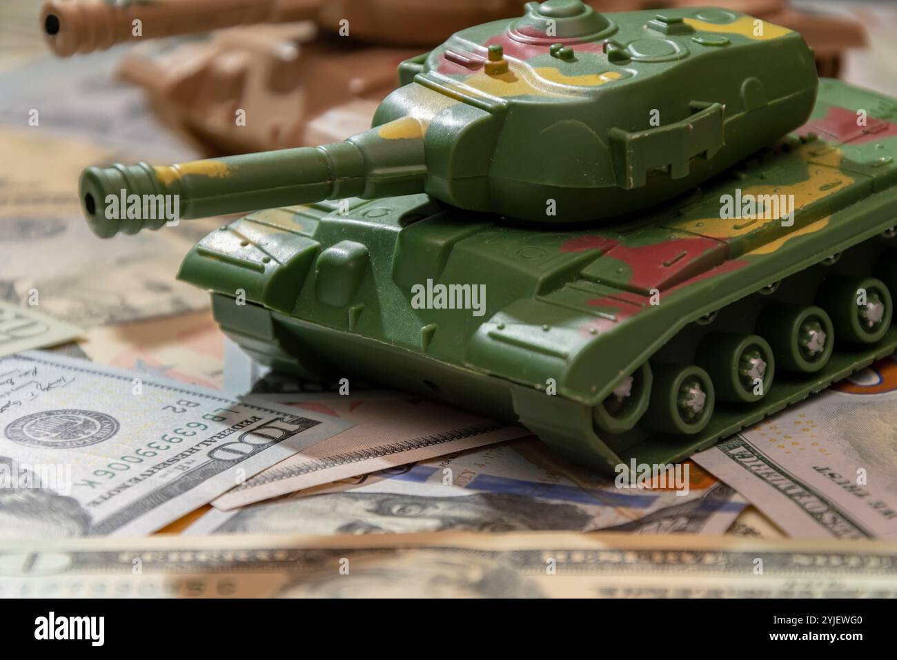 Two military tanks, American dollars, close-up. Concept: arms spending ...