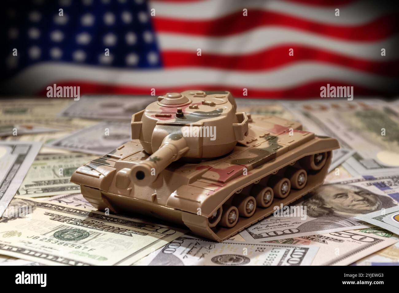Two military tanks, American dollars, close-up. Concept: arms spending ...