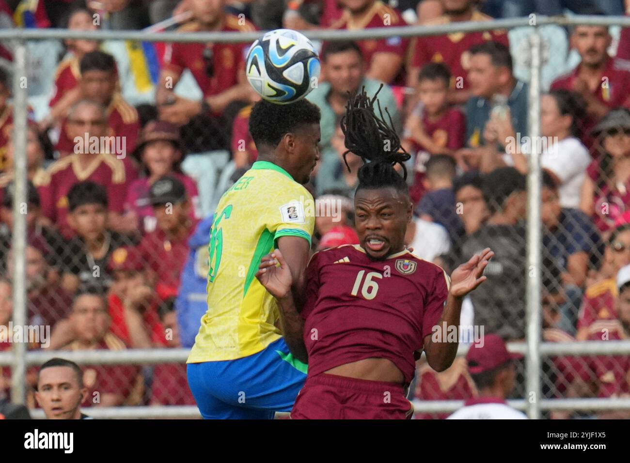 Brazil's Abner, left, and Venezuela's Jhon Murillo jump for a header ...