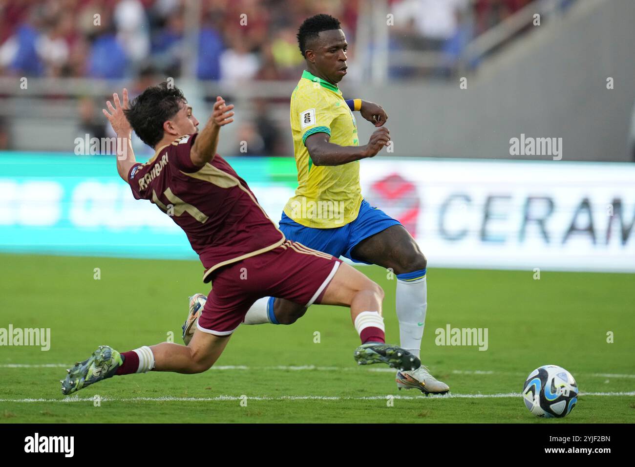 Brazil's Vinicius Junior, right, dribbles past Venezuela's Jon Aramburu ...
