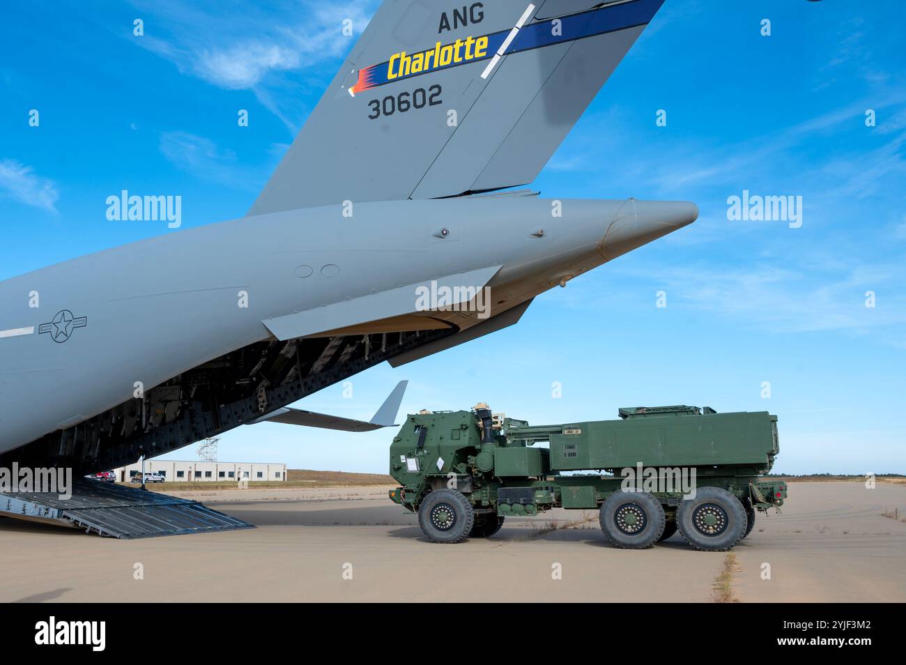 An M142 High Mobility Artillery Rocket System (HIMARS) is loaded onto a ...