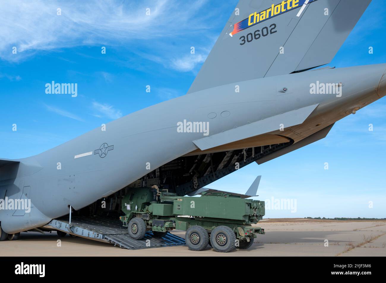 An M142 High Mobility Artillery Rocket System (HIMARS) is loaded onto a ...