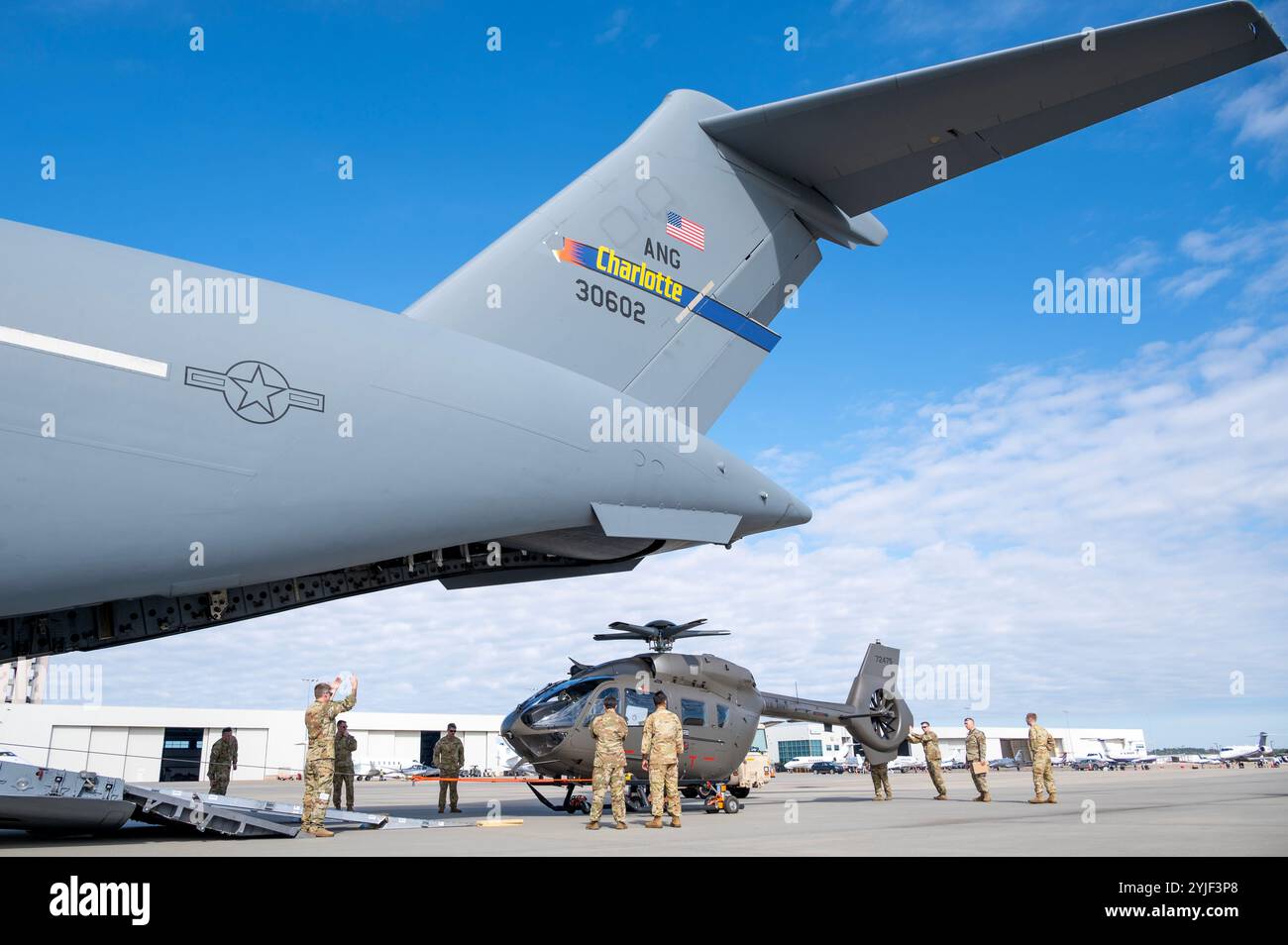 U.S. Airmen and Soldiers of the North Carolina National Guard load a UH ...