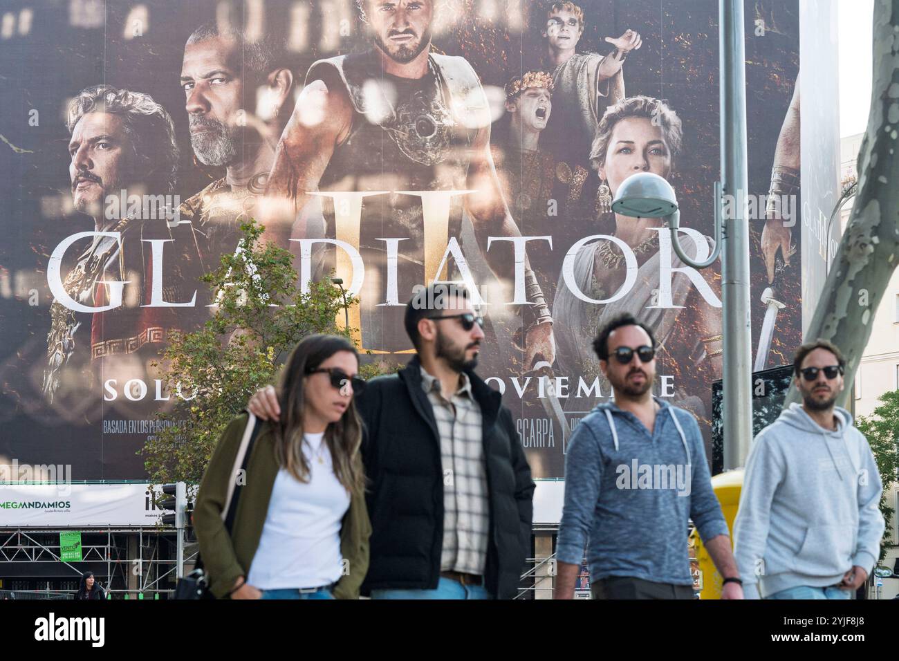 Madrid, Spain. 9th Nov, 2024. Pedestrians walk past a large billboard ...