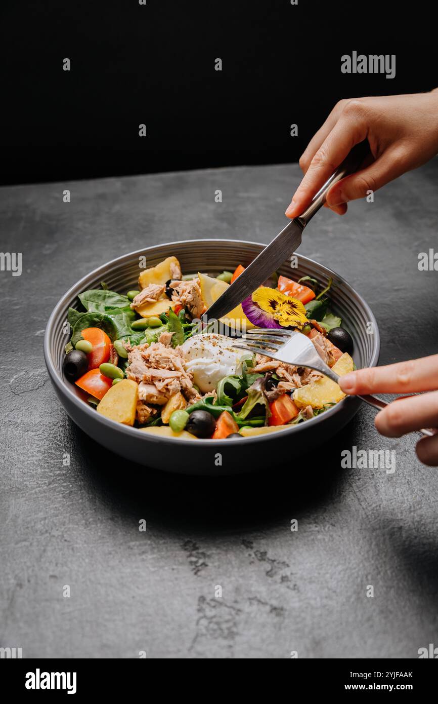 Healthy tuna salad with poached egg, fresh veggies, and edible flower ...