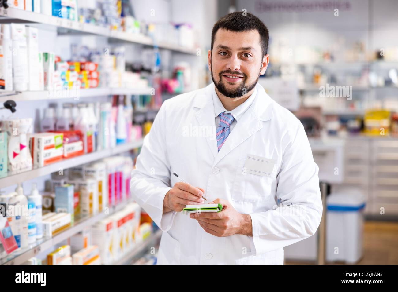 Positive male pharmacist checking hi-res stock photography and images ...